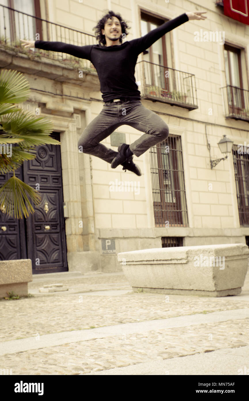 Male dancer performing jump in the air. Urban background Stock Photo ...