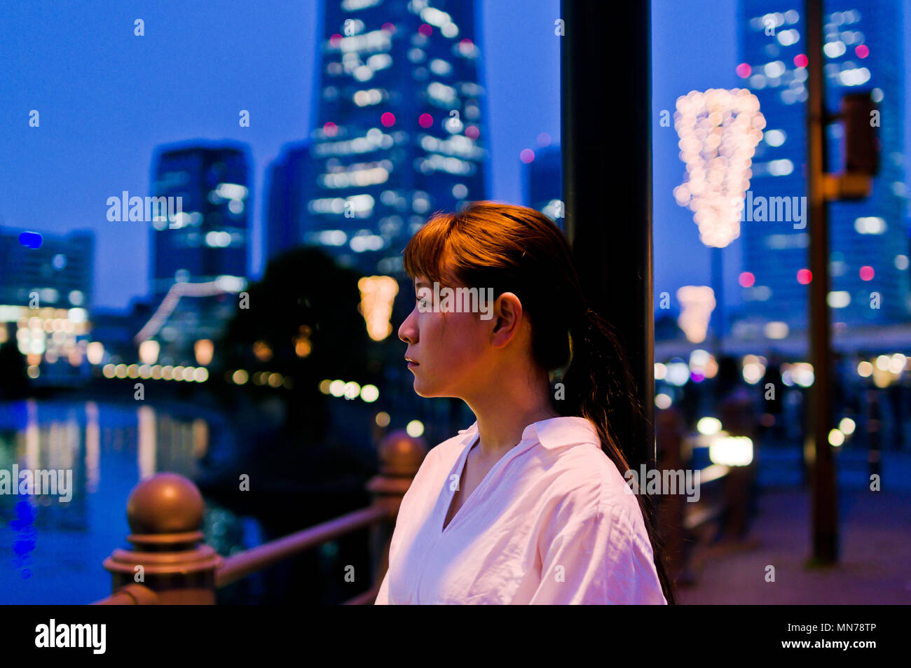 Lingering woman in Night City Stock Photo - Alamy