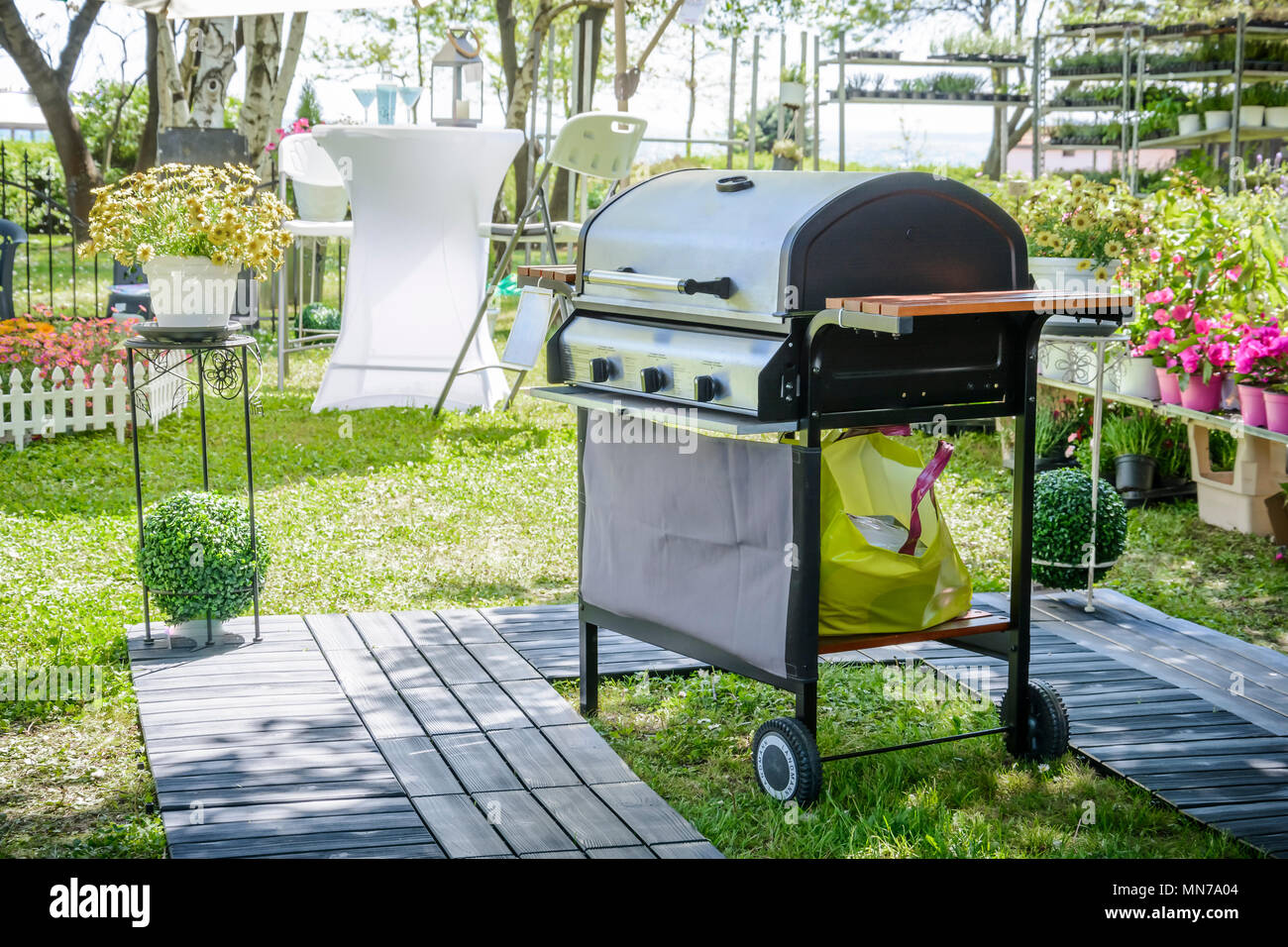 barbecue in the garden with flower and decking. gas barbecue Stock ...