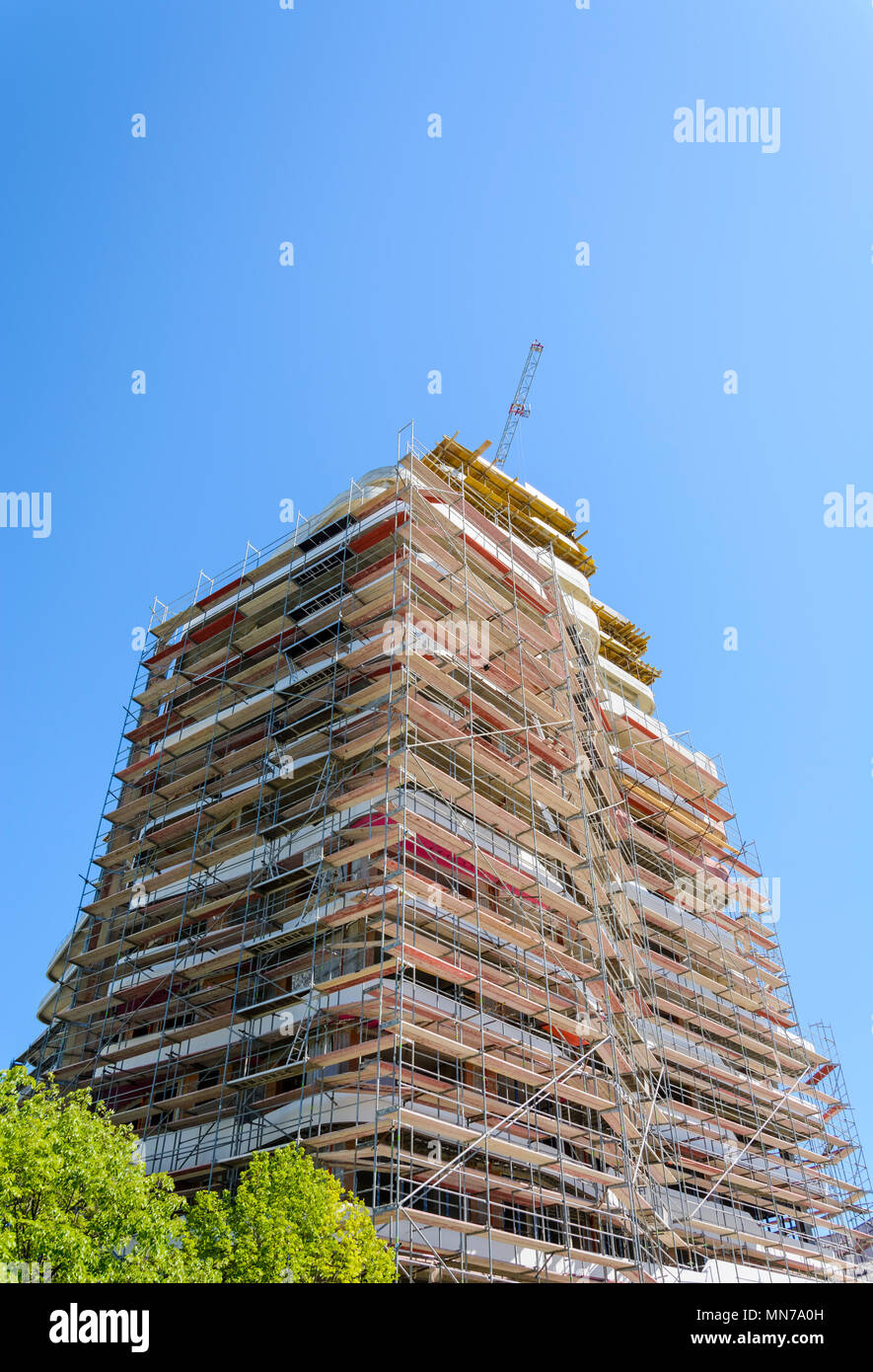 tall Building in construction with scaffolding on blue sky Stock Photo ...