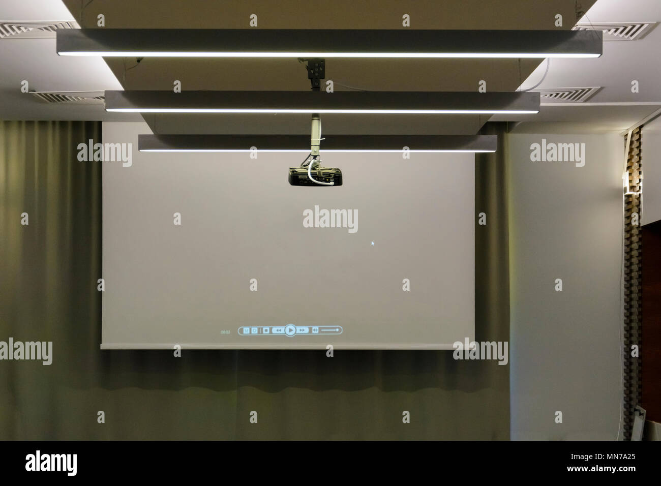 Projector in a room with projector screen on back ground Stock Photo ...