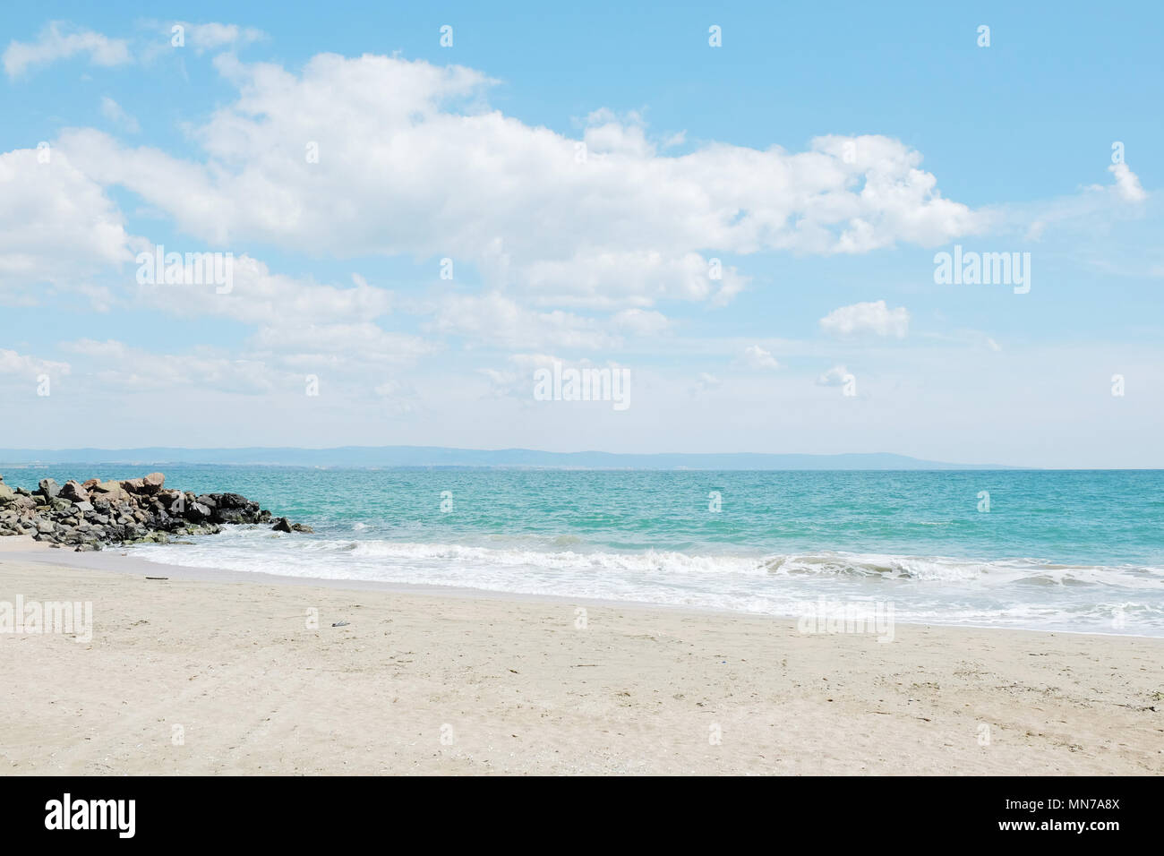 Beach and sea in bright sunlight Stock Photo - Alamy