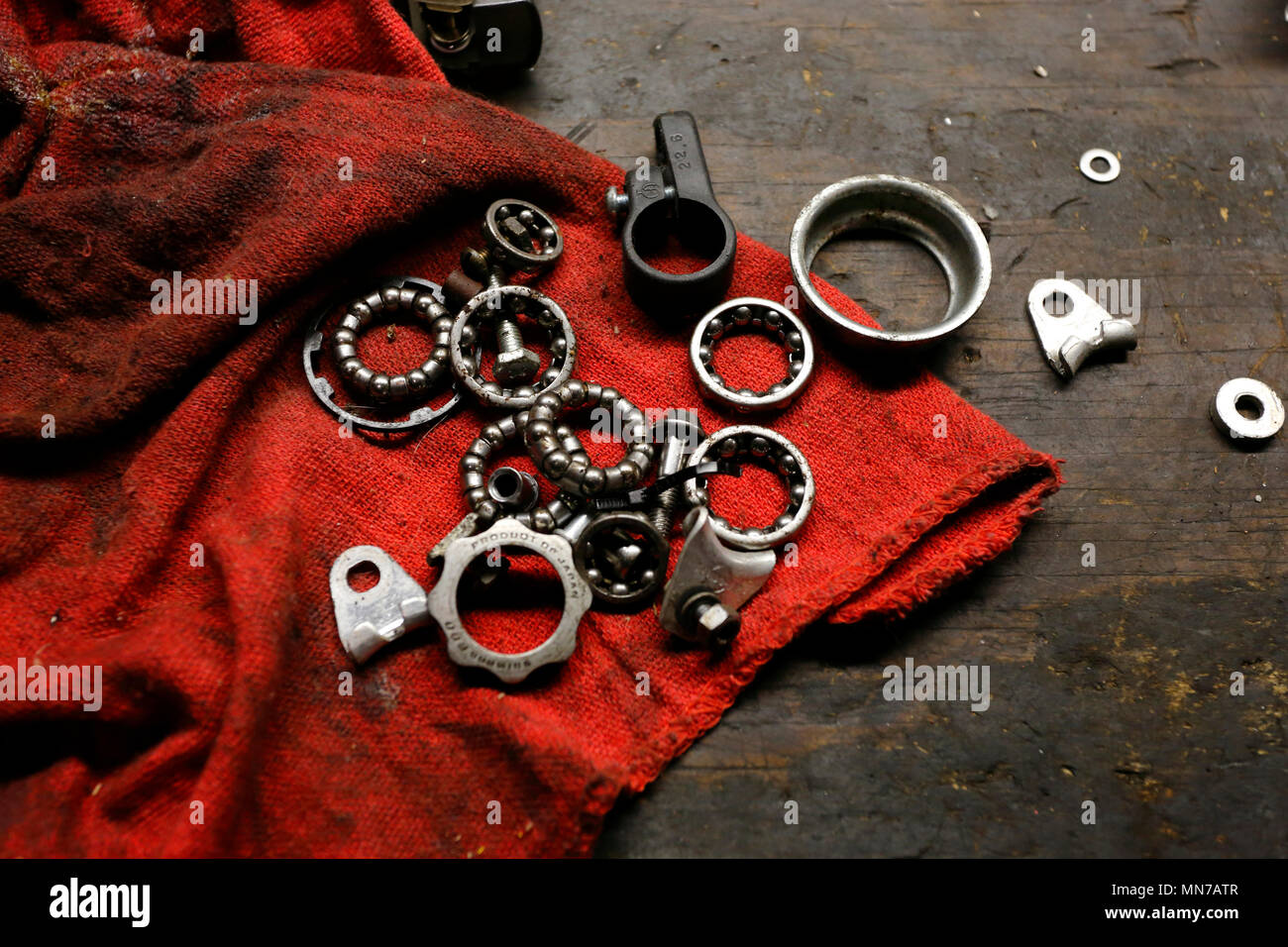 Ball bearings, washers, and other mechanical parts on top of a grease ...