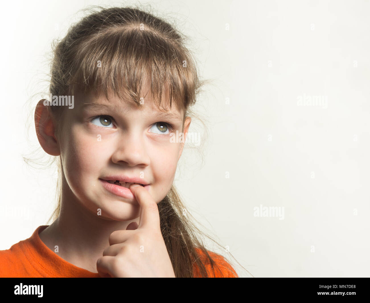 Portrait Of A Shy Girl With A Finger In Her Mouth Looking Up 5033