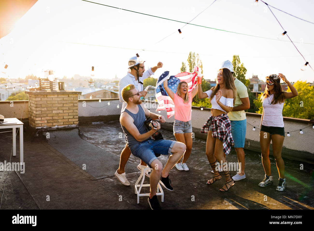 Friends having fun and drinking outdoor on a rooftop get together Stock ...
