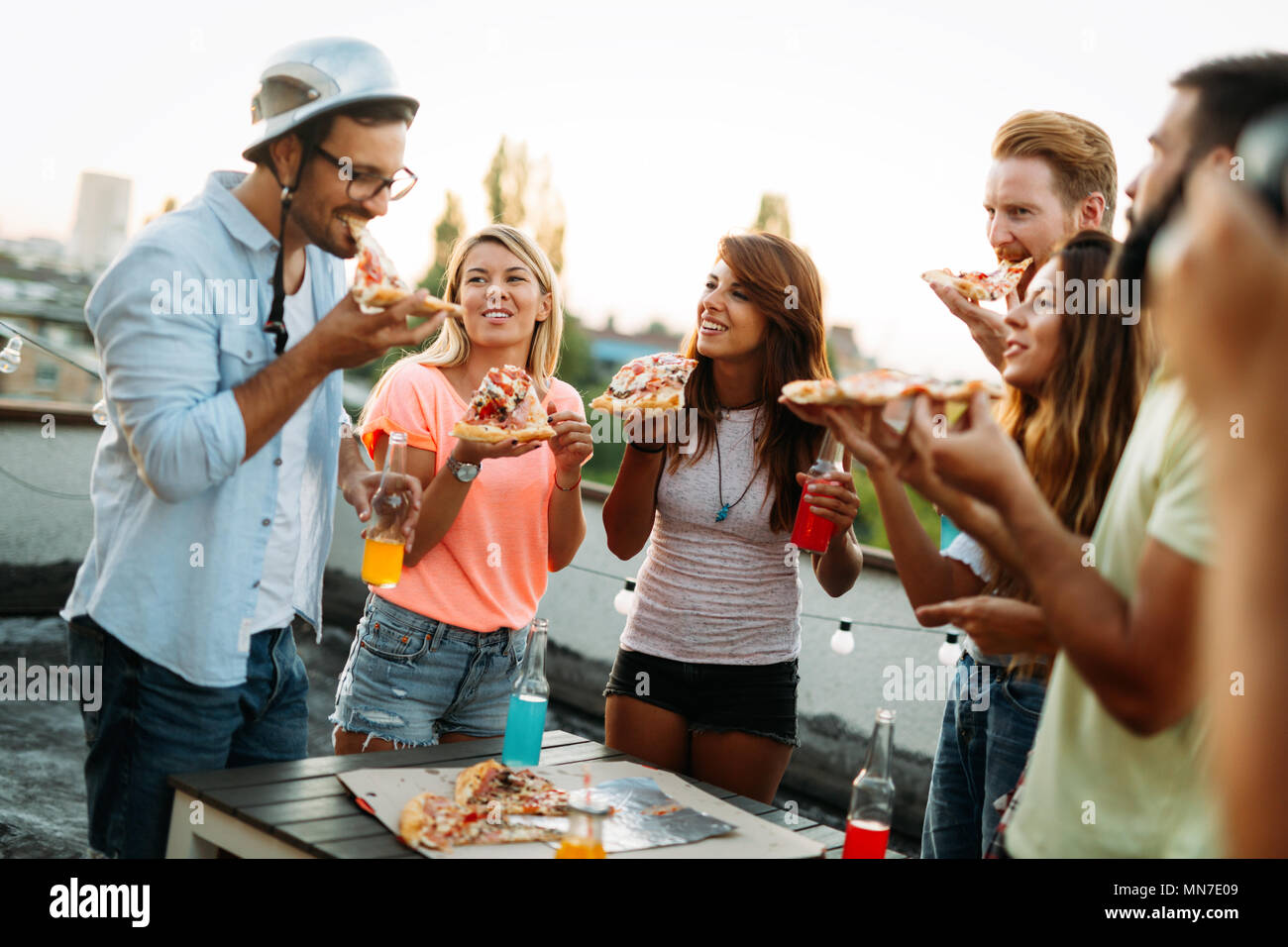 Group of happy friends having party on rooftop Stock Photo - Alamy