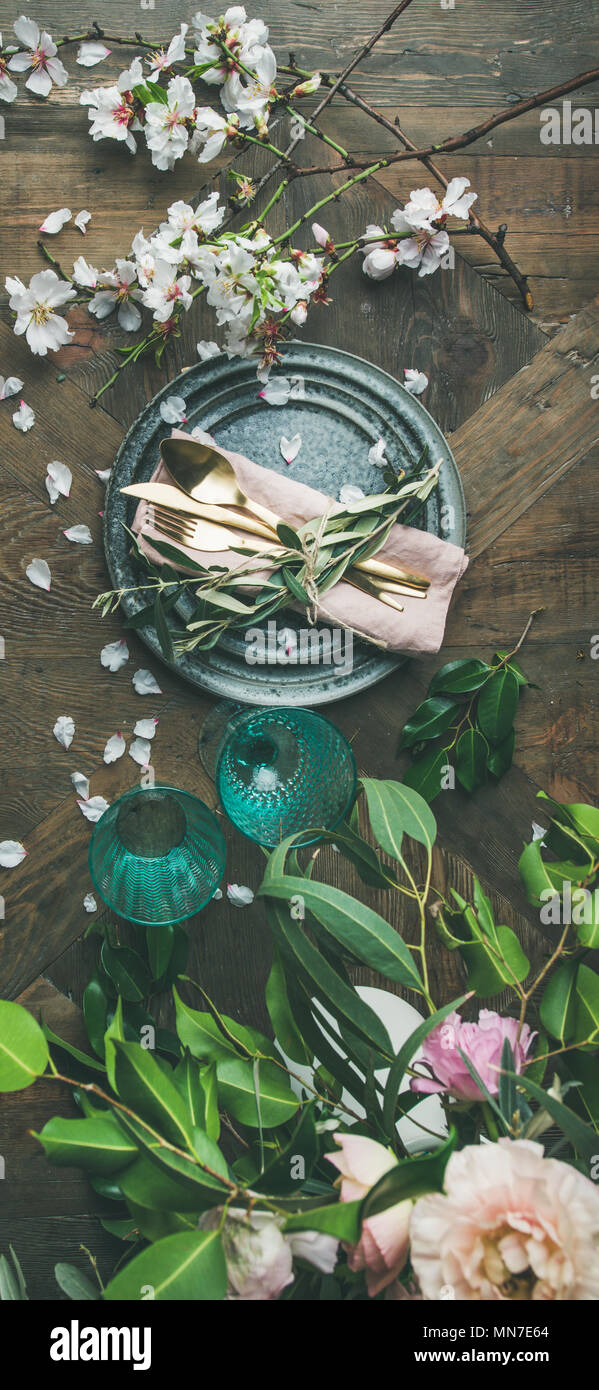 Flat-lay of Table setting with spring flowers, vertical composition ...