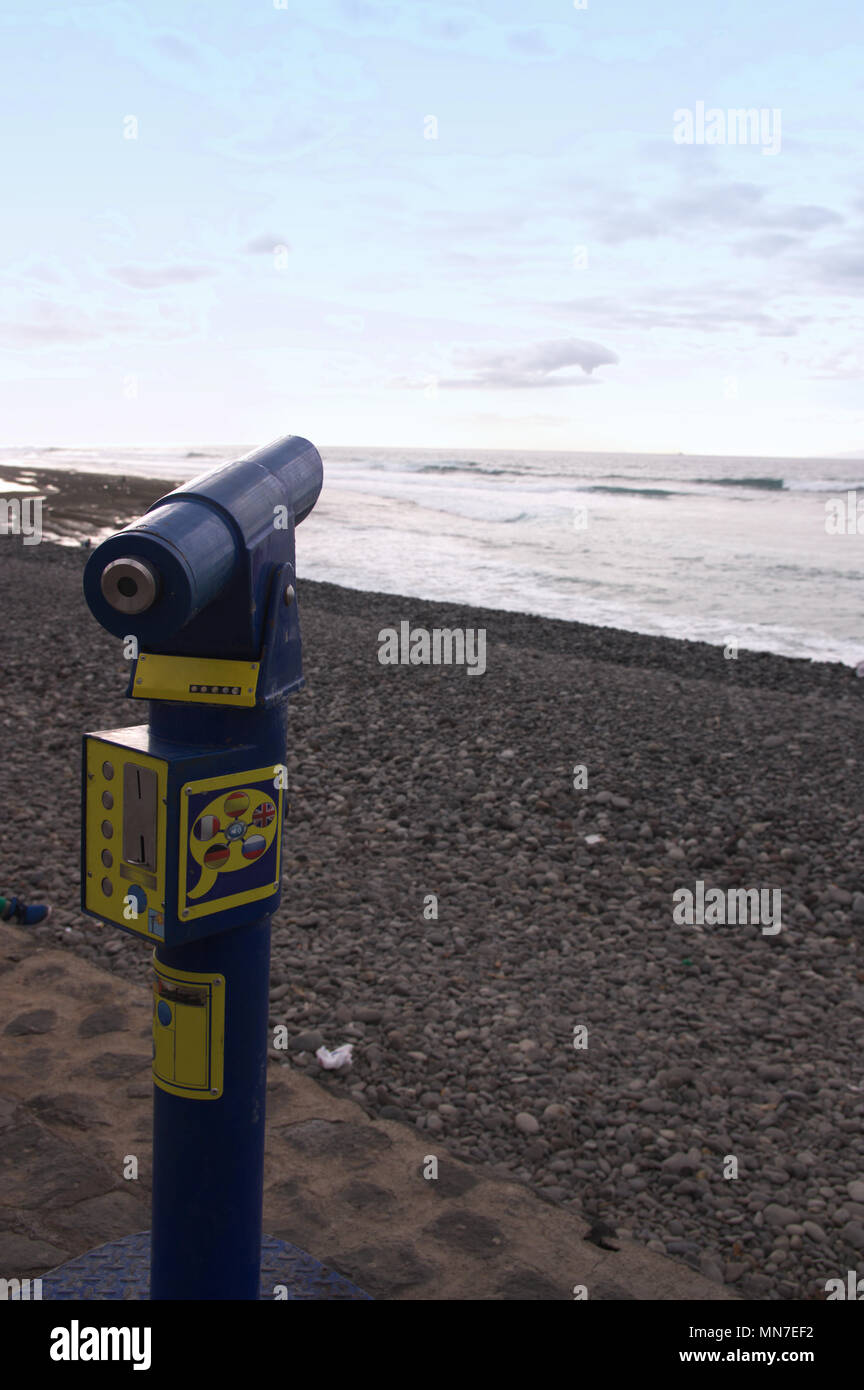 Telescope to see the horizon on a tourist beach Stock Photo - Alamy