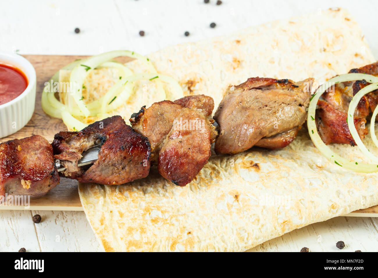 Grilled pork kebab with onion and sauce Stock Photo - Alamy