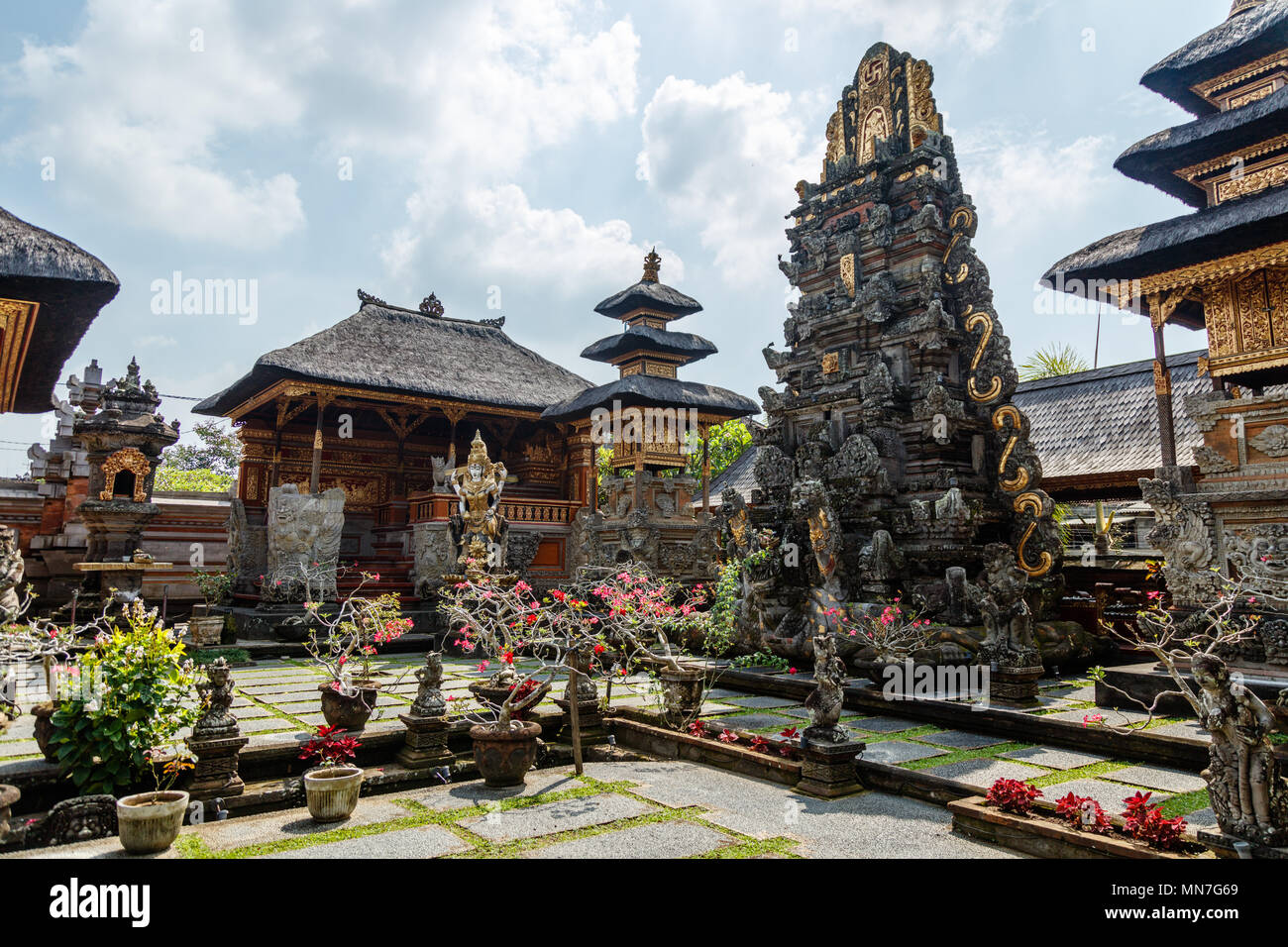 A padmasana shrine topped with a golden empty throne decorated with the ...