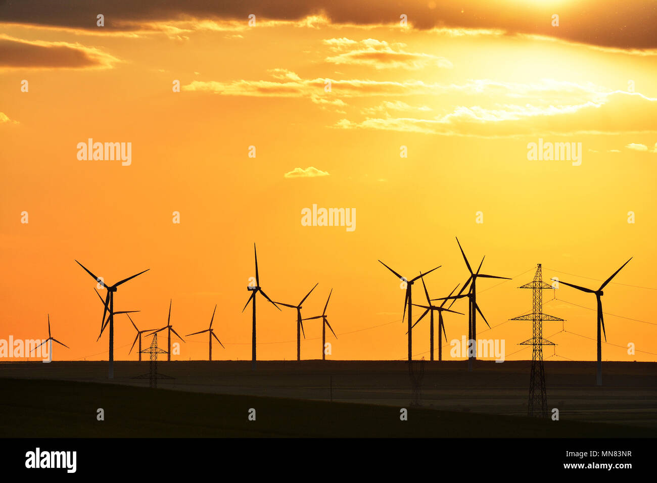 Sunset with wind turbines in Dobrogea , Romania Stock Photo - Alamy