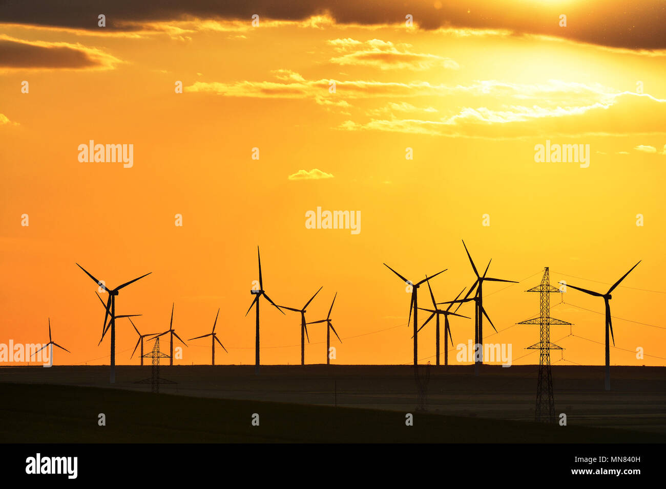 Sunset with wind turbines in Dobrogea , Romania Stock Photo - Alamy