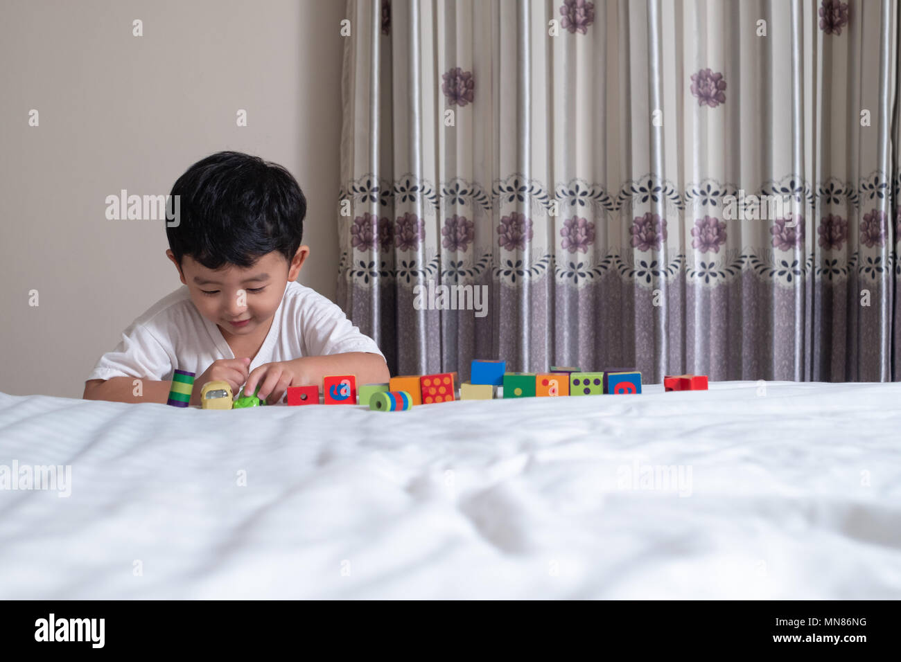 3 years old little cute Asian boy play toy or square block puzzle at ...