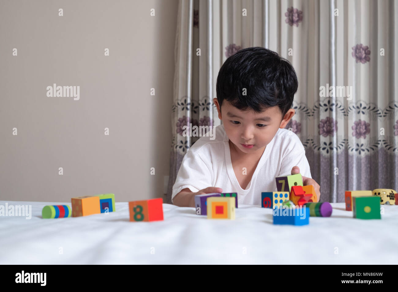3 years old little cute Asian boy play toy or square block puzzle at ...
