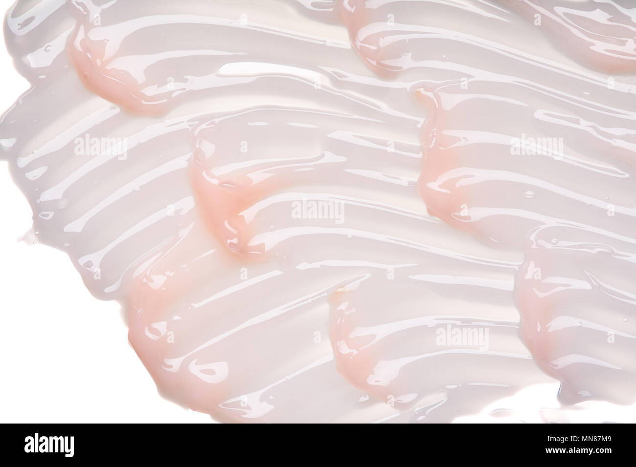 Gently pink creamy texture isolated on white background. Smear of face ...
