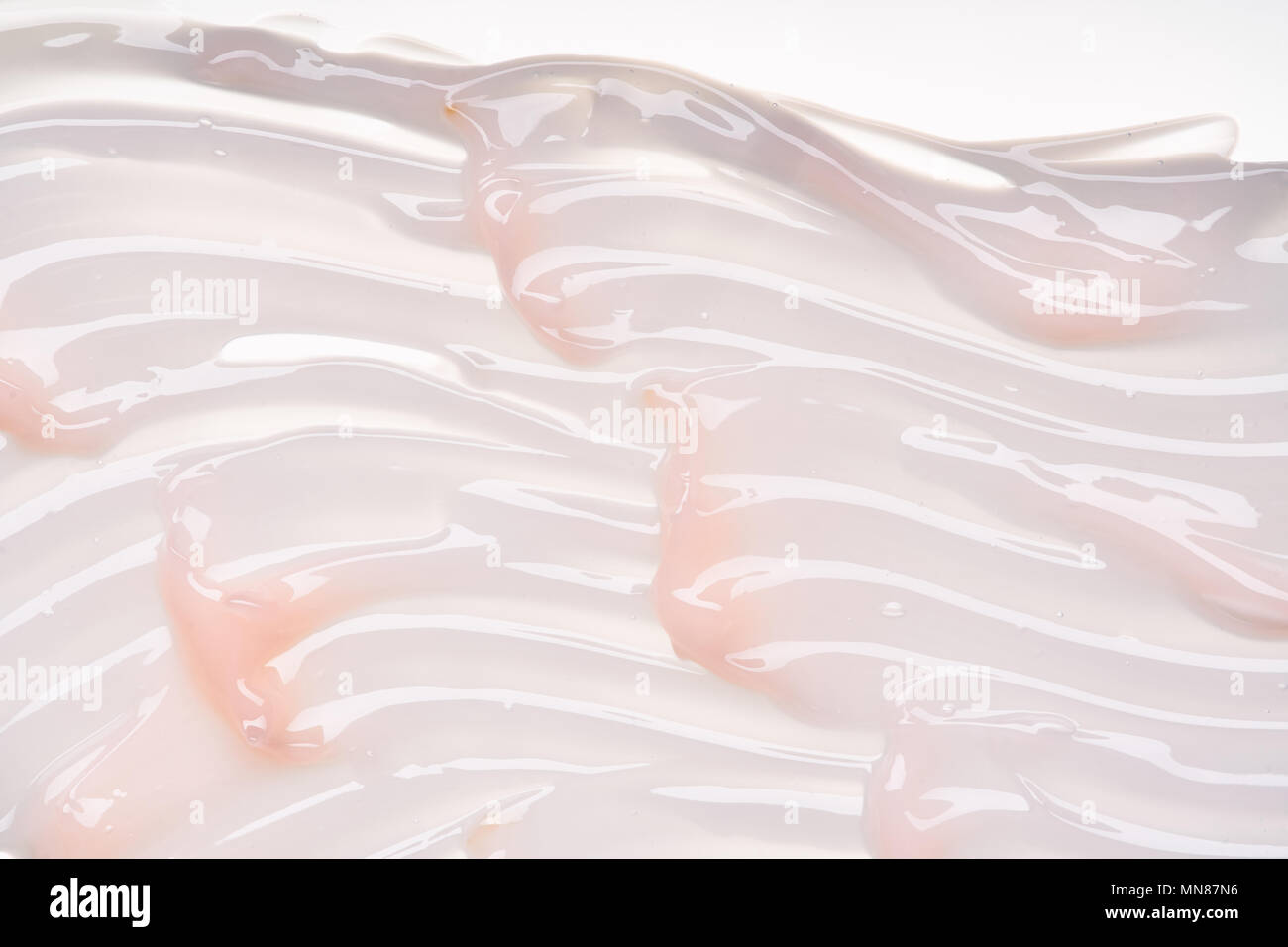 Gently pink creamy texture isolated on white background. Smear of face ...