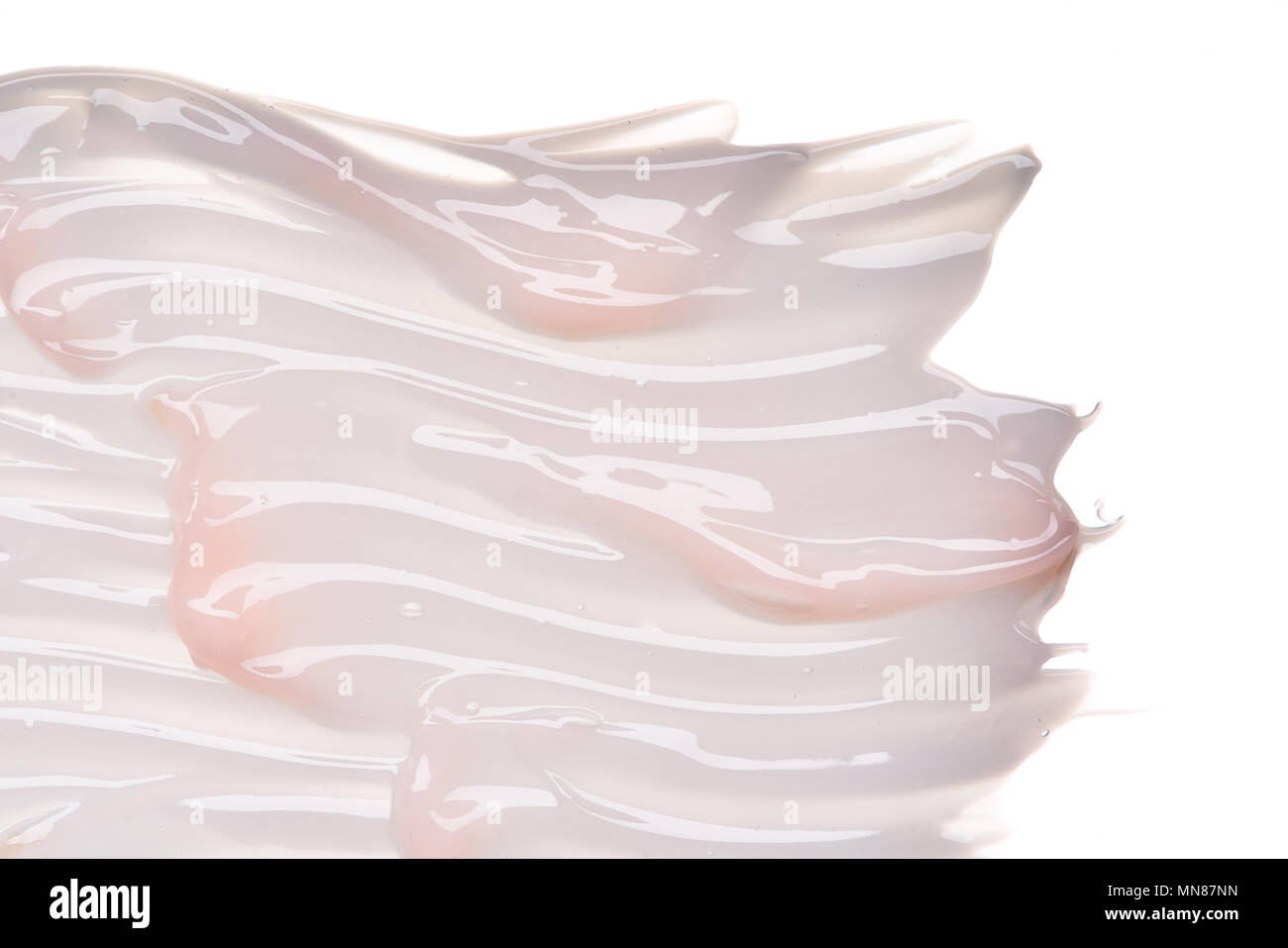 Gently pink creamy texture isolated on white background. Smear of face ...