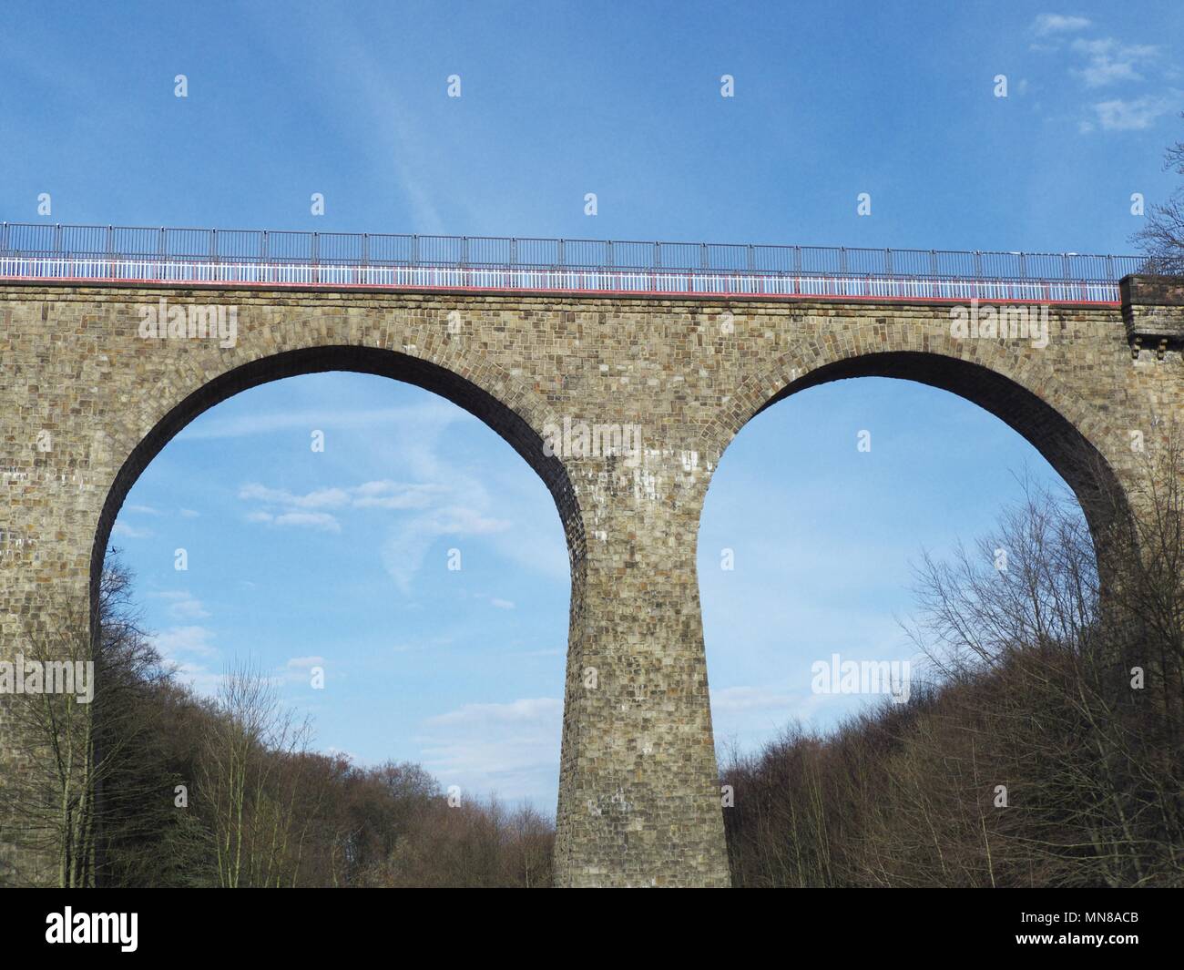 Stone arch bridge over a valley Stock Photo - Alamy