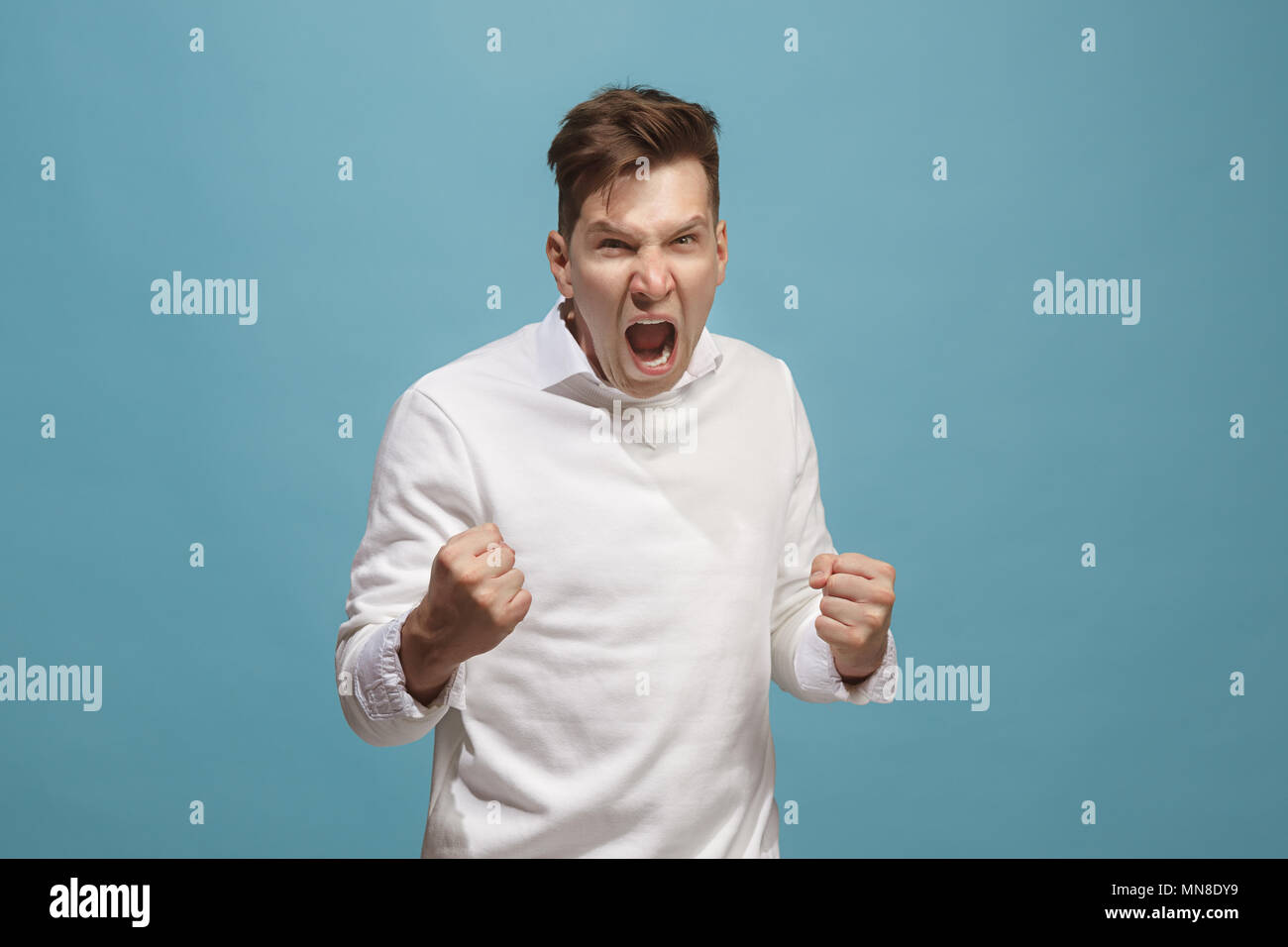The young emotional angry man screaming on studio background Stock ...