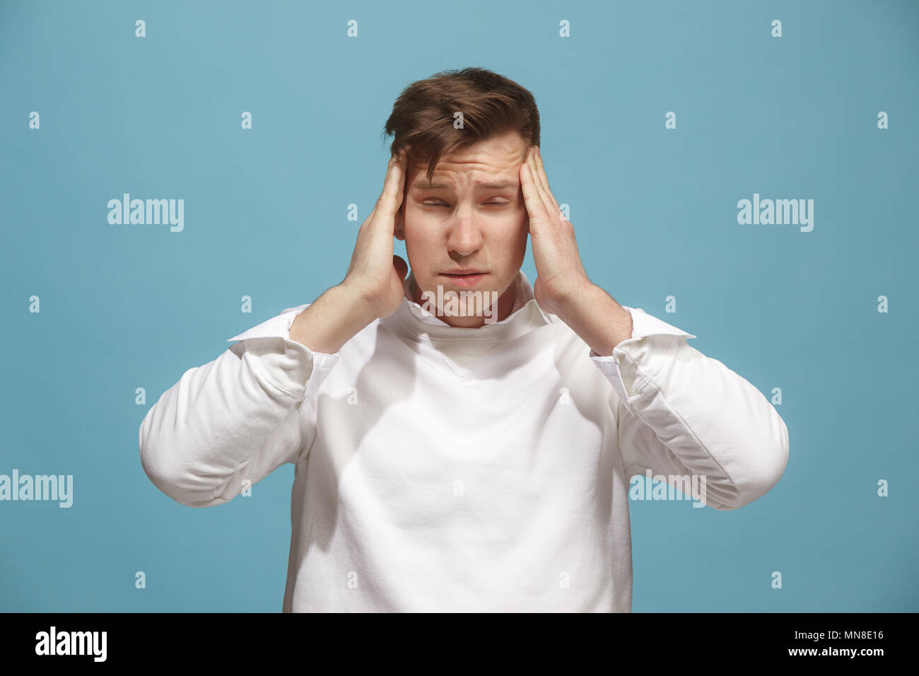 Man having headache. Isolated over background Stock Photo - Alamy