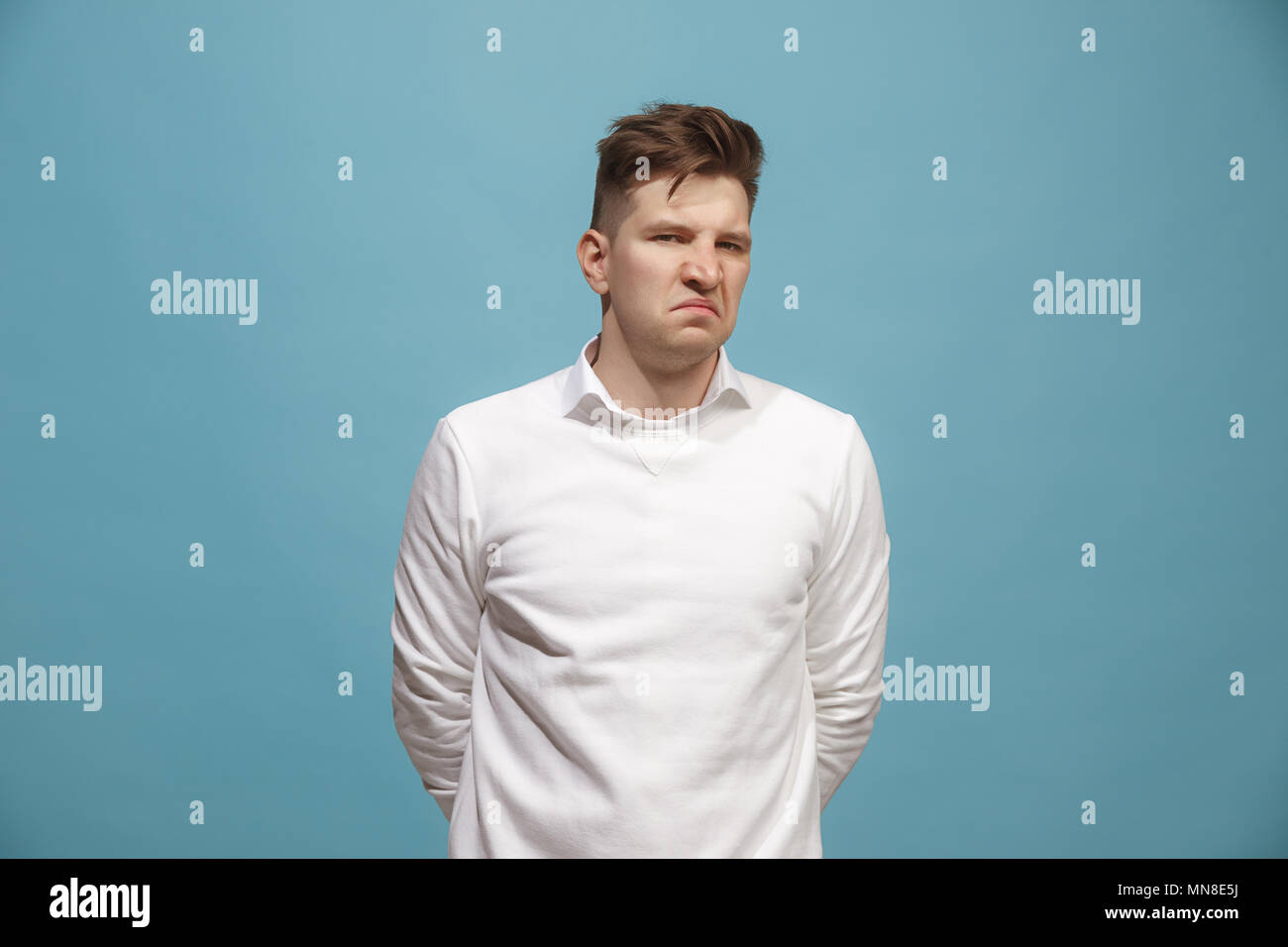 Beautiful bored man isolated on studio background Stock Photo - Alamy