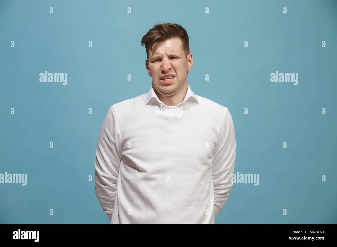 Beautiful bored man isolated on studio background Stock Photo - Alamy