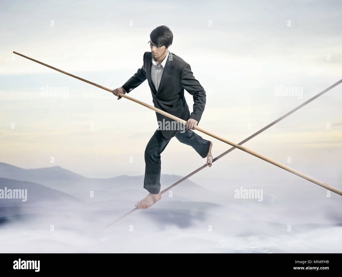 Conceptual picture of a young businessman - slackliner Stock Photo - Alamy