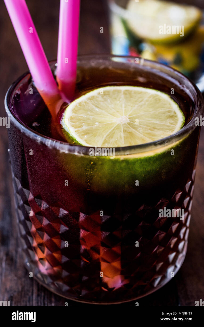 Whiskey Cola Cocktail with lime and ice. (cuba libre). Beverage concept Stock Photo - Alamy
