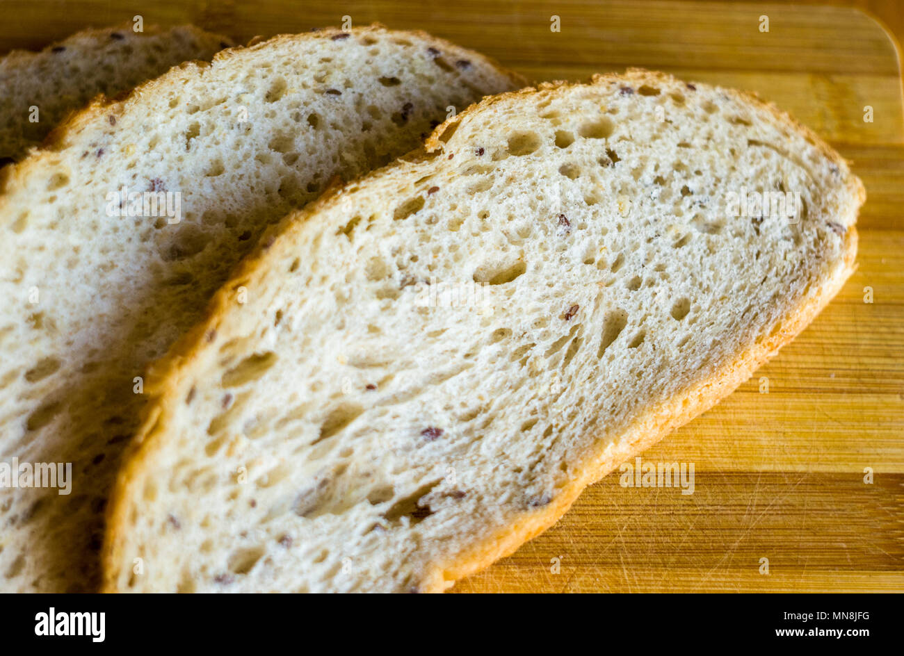 sliced whole wheat breads on a chopping Board Stock Photo - Alamy