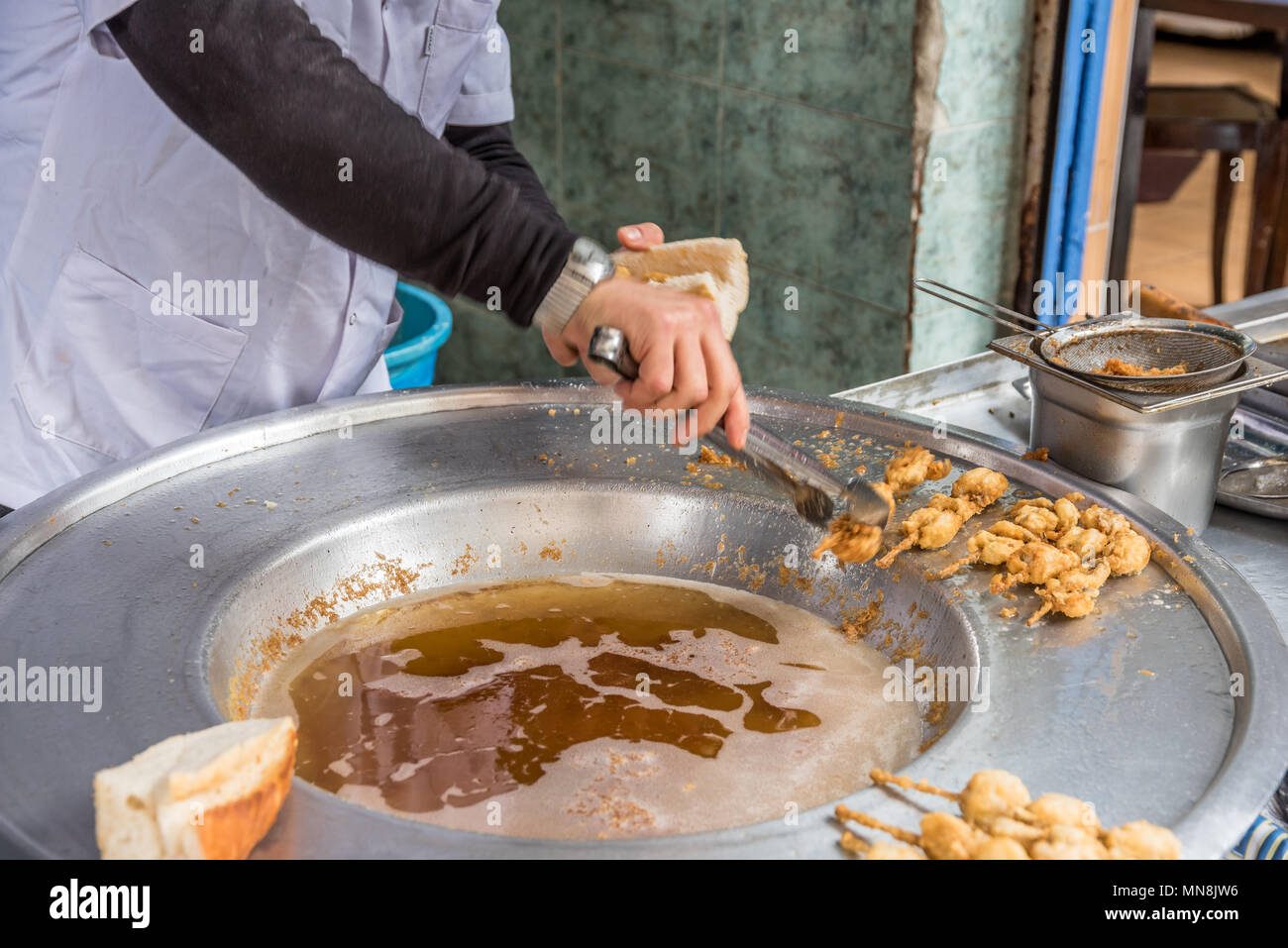 Turkish style chopped mussels (Midye tava) fried in deep oil in a ...