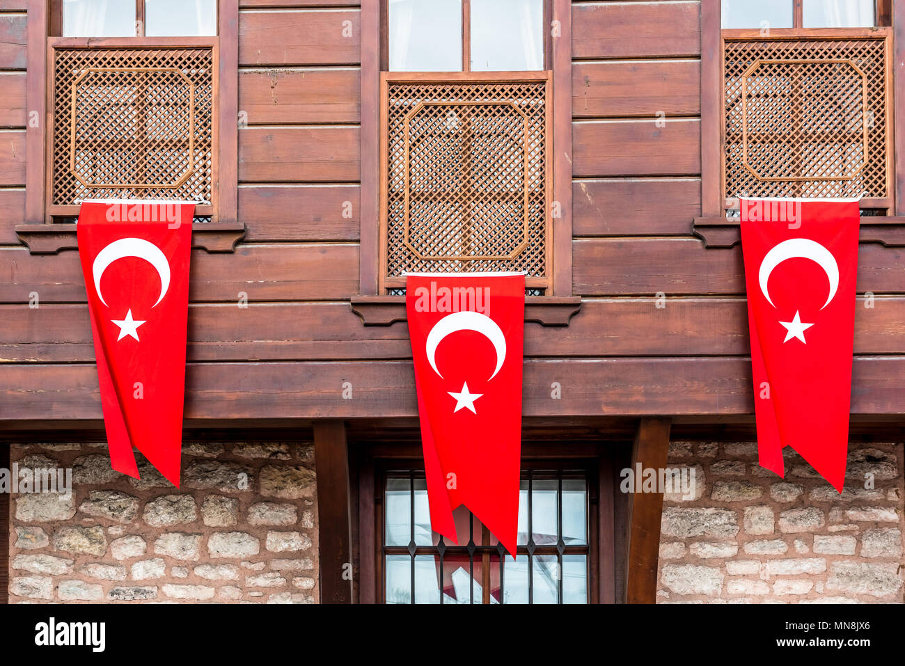 Three Turkish flag hanging on wooden house wall.Turkish flag concept ...