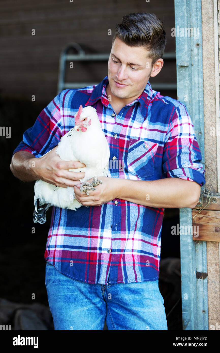 Man holding rooster hi-res stock photography and images - Alamy