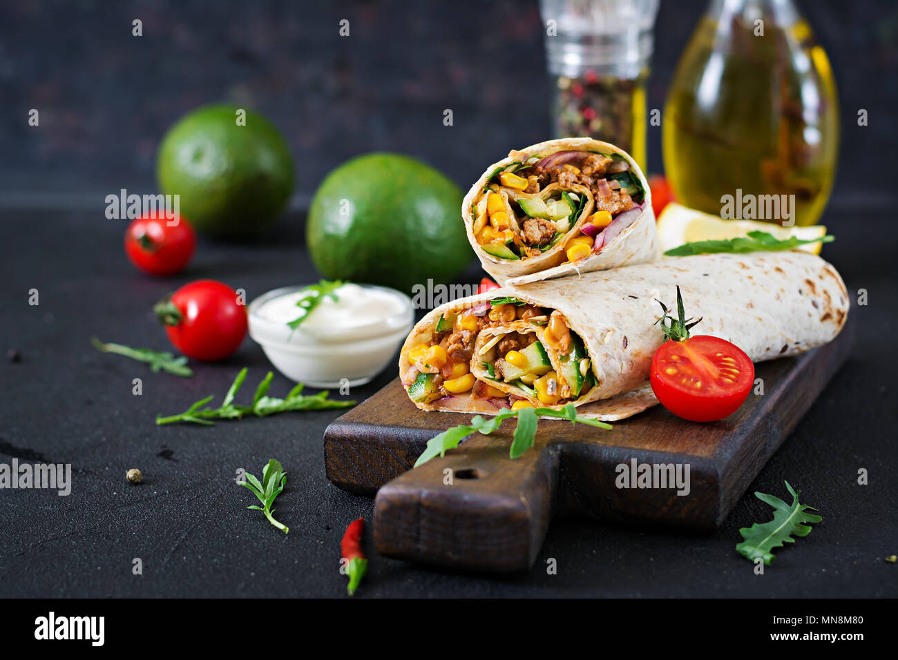 Burritos wraps with beef and vegetables on black background. Beef burrito, mexican food Stock ...