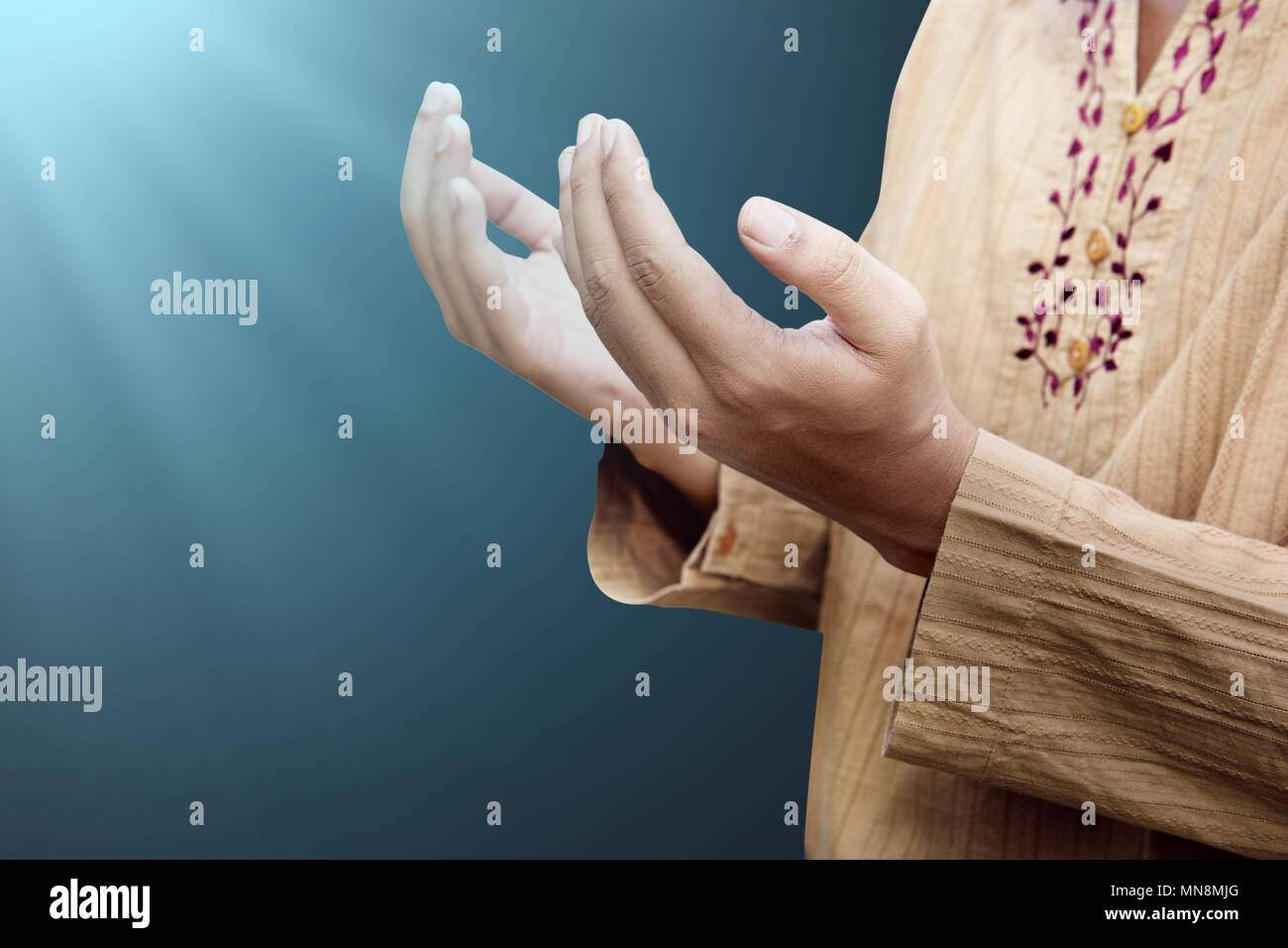 Muslim man pray to god over bright background Stock Photo - Alamy