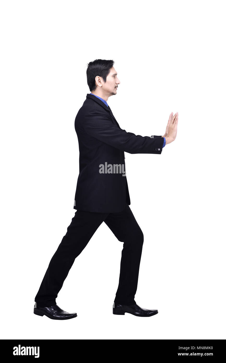 Portrait of asian businessman pushing something posing isolated over ...