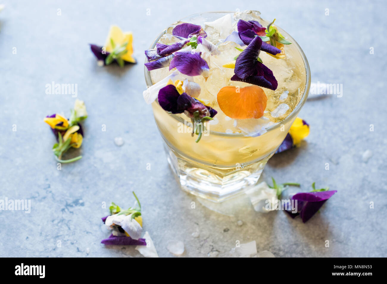 Herbal Iced Tea Cocktail with Edible Flowers and Crushed Ice. Organic ...
