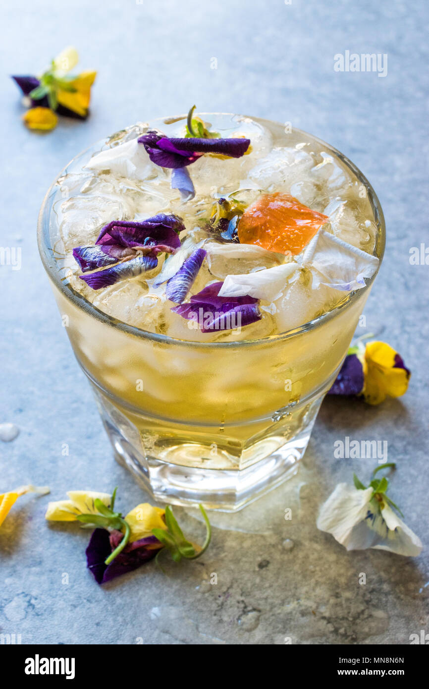 Herbal Iced Tea Cocktail with Edible Flowers and Crushed Ice. Organic ...