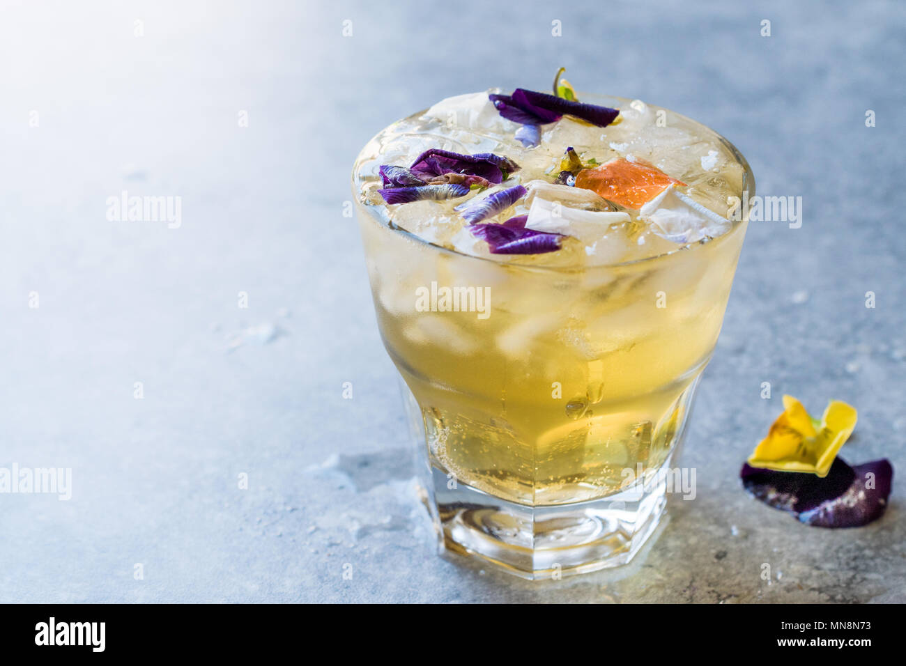 Herbal Iced Tea Cocktail with Edible Flowers and Crushed Ice. Organic ...