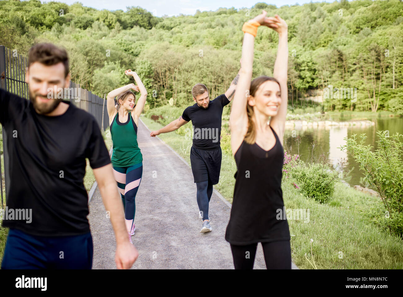 Group of friends stretching after the morning run in the park Stock ...