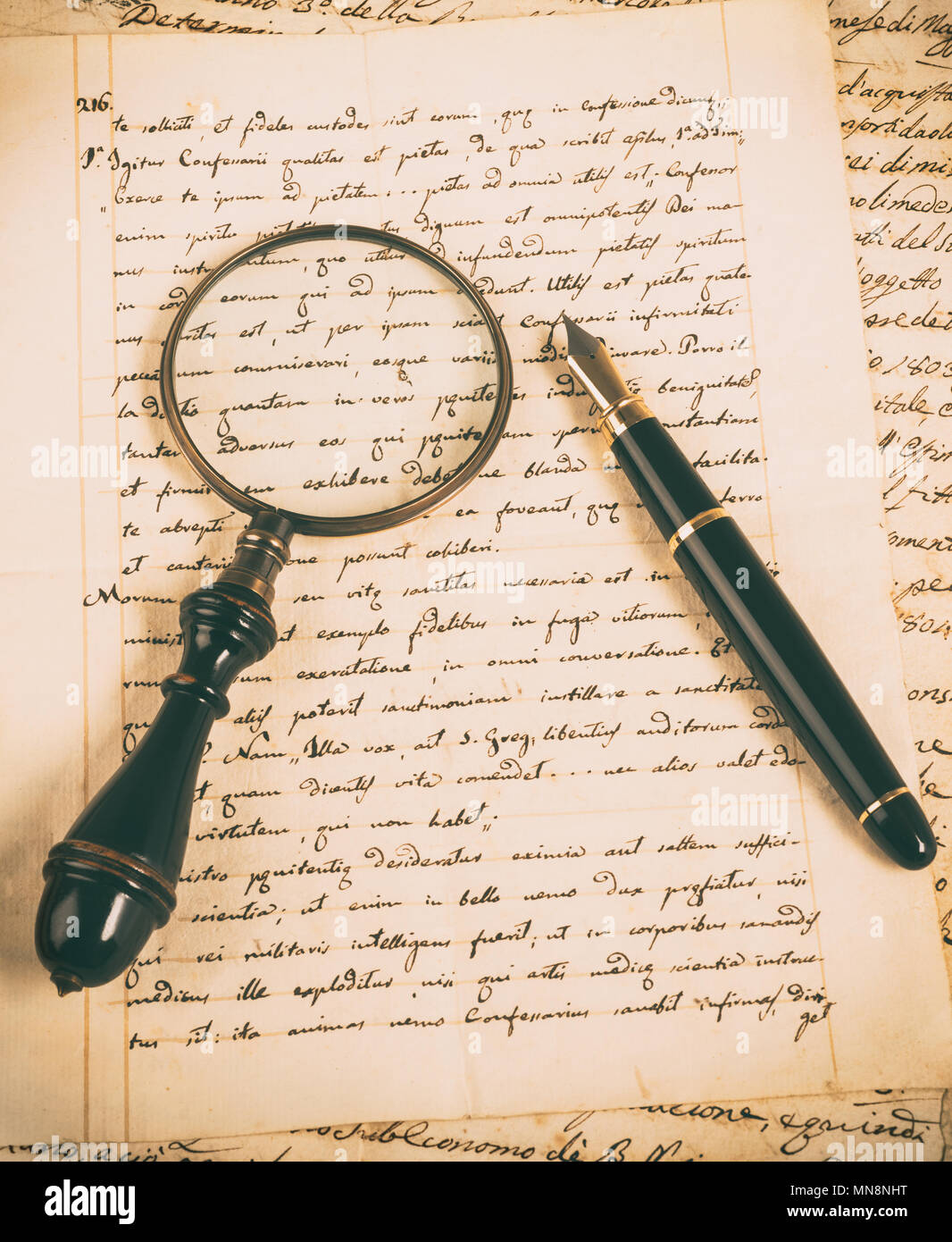 Fountain pen and magnifying glass on a letter Stock Photo - Alamy
