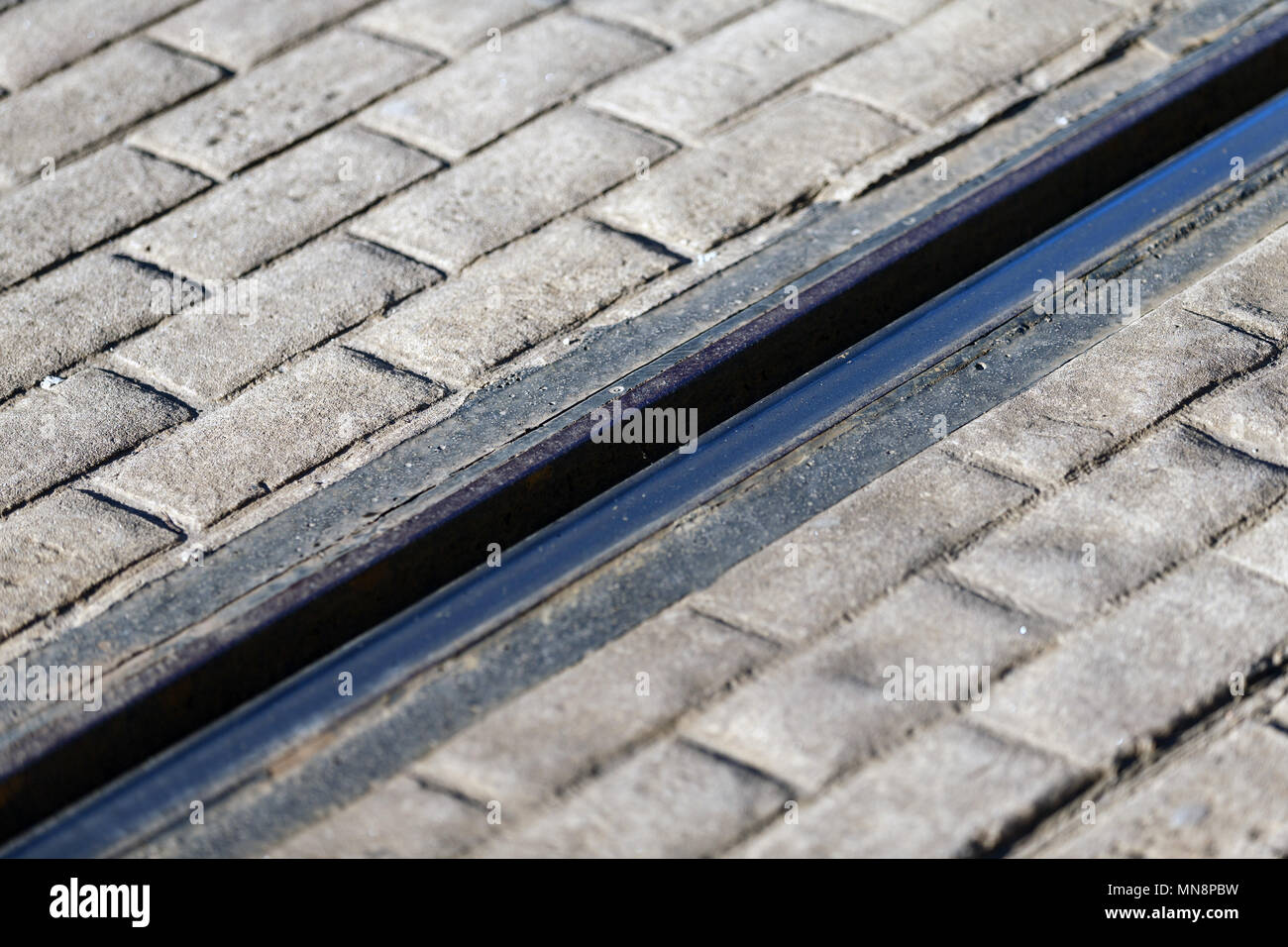 A close up of a single gauntlet tram track Stock Photo - Alamy
