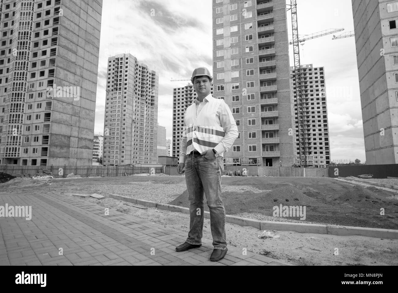 Engineer safety vest hardhat Black and White Stock Photos & Images - Alamy