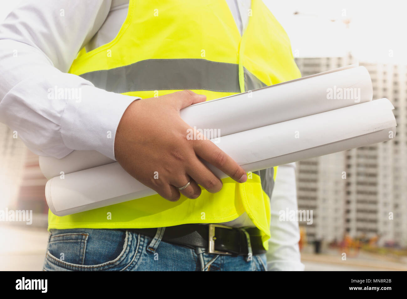 Closeup image of construction engineer holding rolled blueprints Stock ...