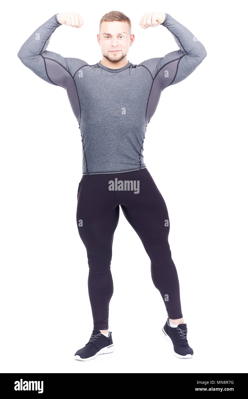 Portrait of young confident bodybuilder or gym instructor posing on ...