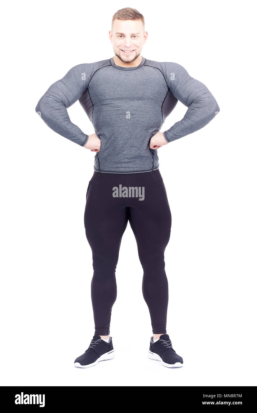 Portrait of young confident bodybuilder or gym instructor posing on ...