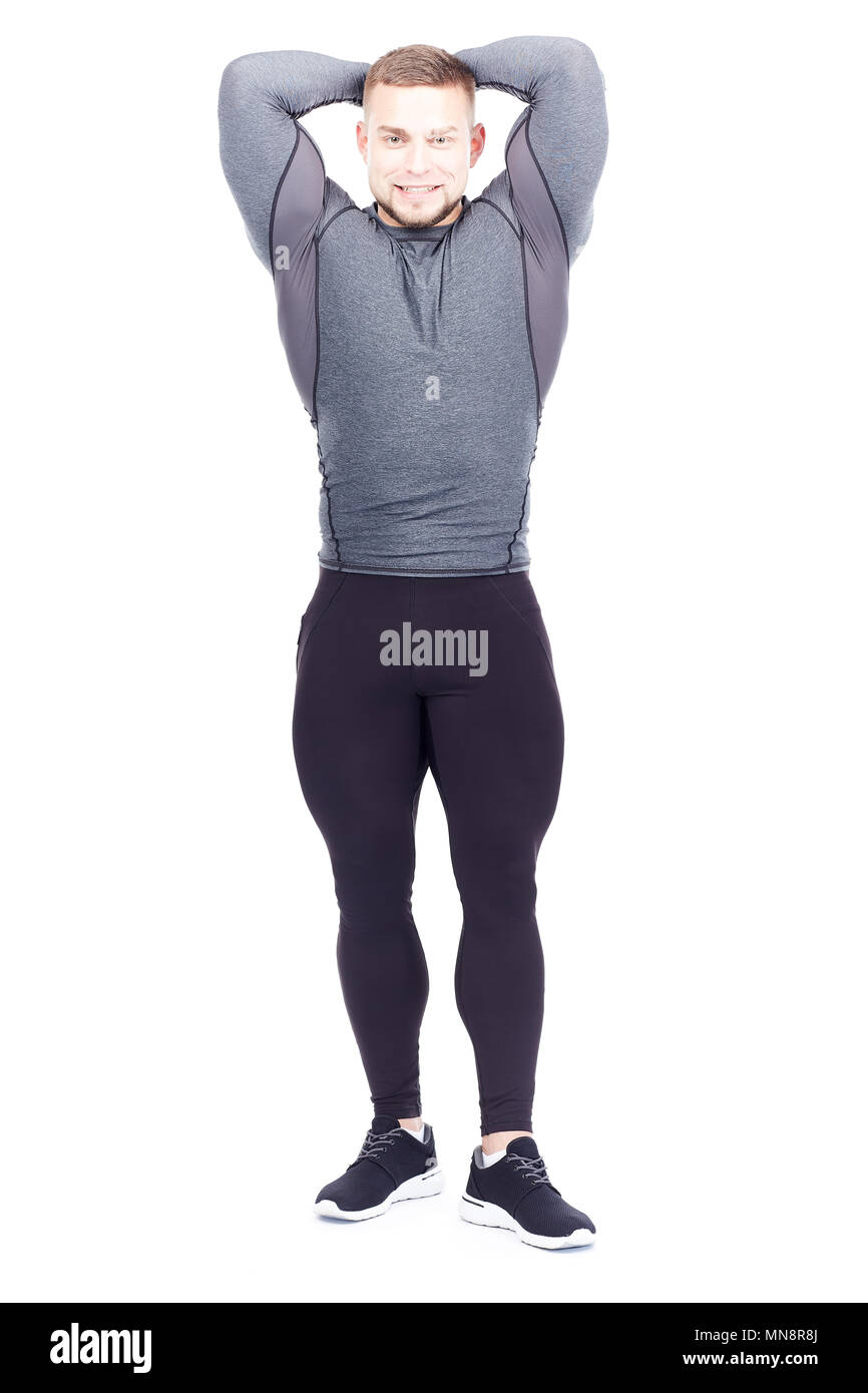 Portrait of young confident bodybuilder or gym instructor posing on ...