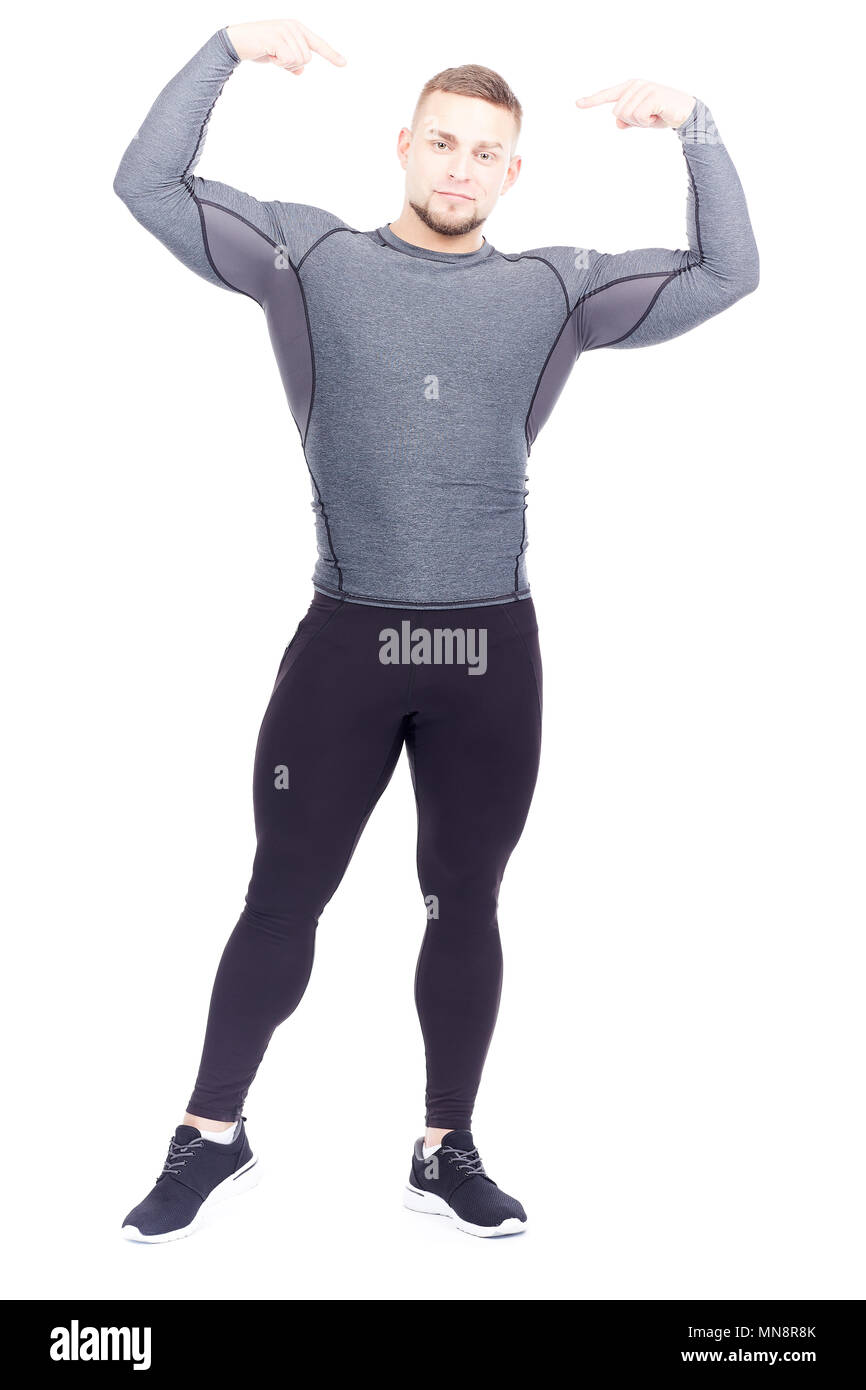 Portrait of young confident bodybuilder or gym instructor posing on ...