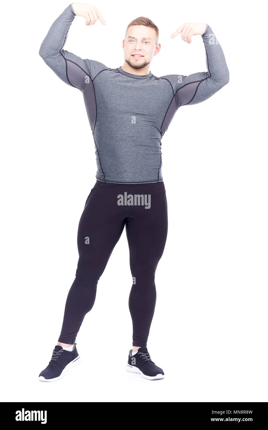 Portrait of young confident bodybuilder or gym instructor posing on ...