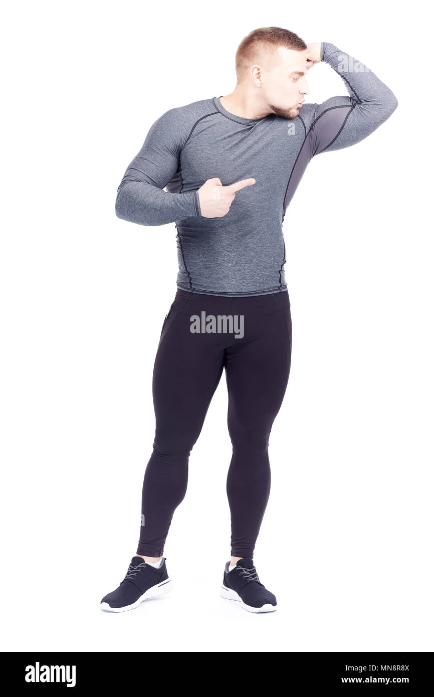Portrait of young confident bodybuilder or gym instructor posing on ...