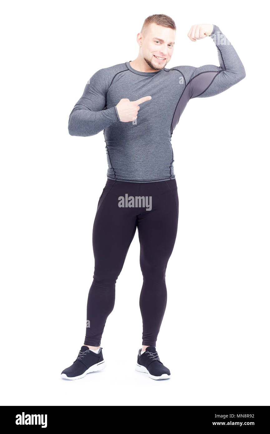 Portrait of young confident bodybuilder or gym instructor posing on ...